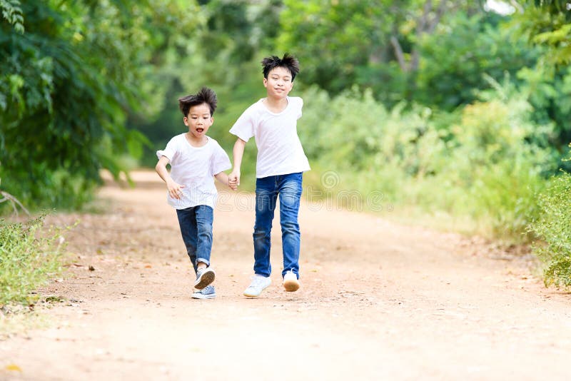 Two boy run in the park stock photo. Image of park, fashion - 85015510