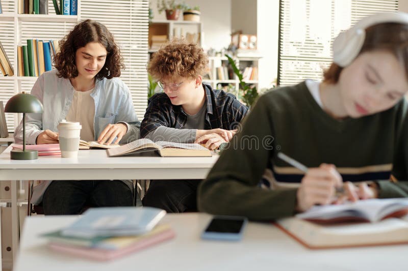 Two Boy Students Working at Table in College Class Stock Photo - Image ...