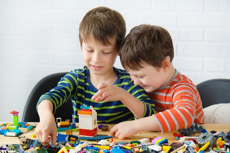 Two Boys are Assembling a Constructor Together, Building Something ...