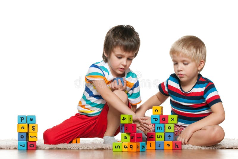 Two boys with blocks stock photo. Image of sitting, learning - 34853026