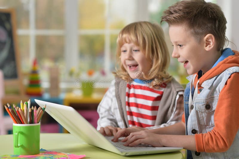 Two Boys at Class Using Laptop and Writing Stock Photo - Image of face ...
