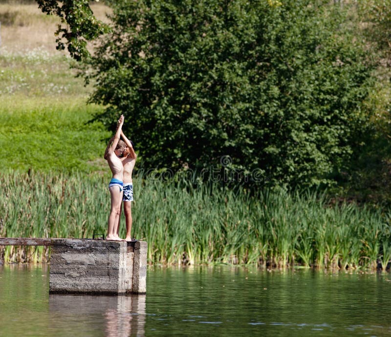 Two Boys Diving in the Lake. Stock Image - Image of child, hair: 129546295