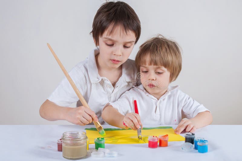 Two Boys Draw Together. Everyone Draws on Their Own Half of the Paper ...