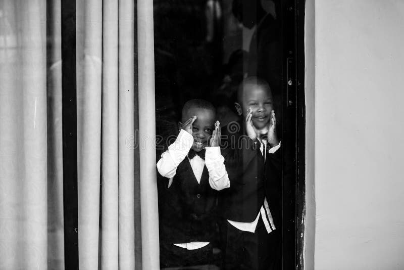 Two Boys In Front Of Glass Window Stock Image - Image of family, outfit ...