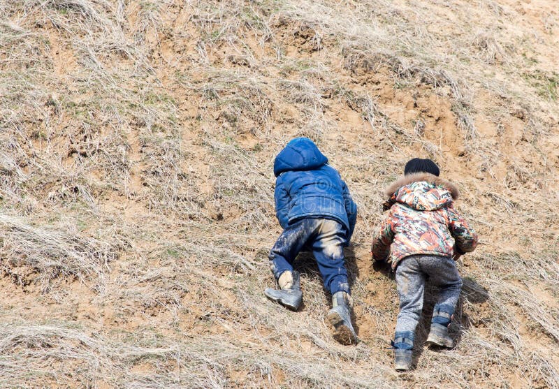 Two boys are going uphill stock photo. Image of play - 100100676