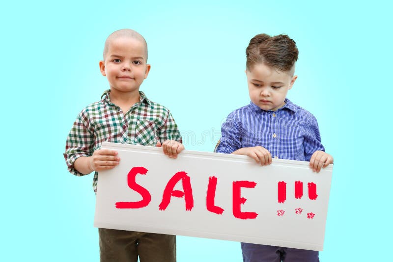Two boys holding a sign stock image. Image of background - 150593149