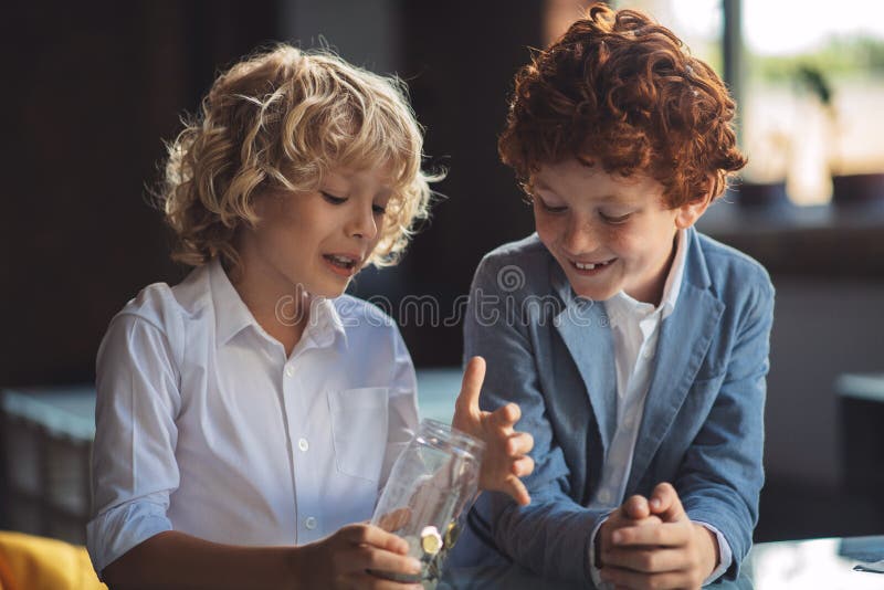 Two Boys Investigating the Jar with Coins Stock Photo - Image of ...