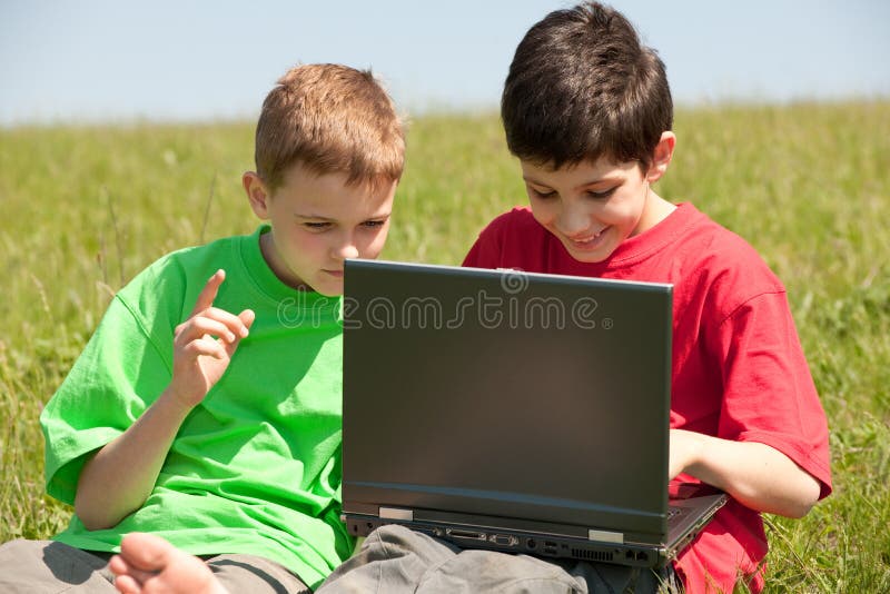 Two Boys with Laptop on the Meadow Stock Photo - Image of feeling ...