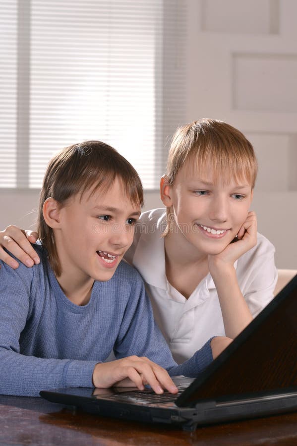 Two boys with a laptop stock photo. Image of notebook - 30691626