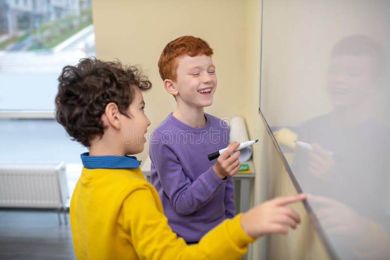 Two Boys Laughing and Writing on the Whiteboard Stock Image - Image of ...