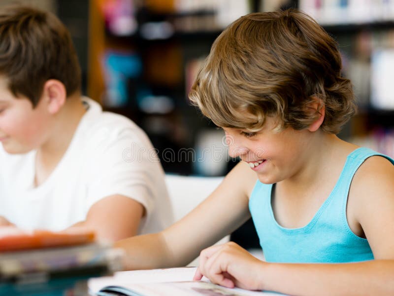 Two boys in library stock image. Image of knowledge - 101528047