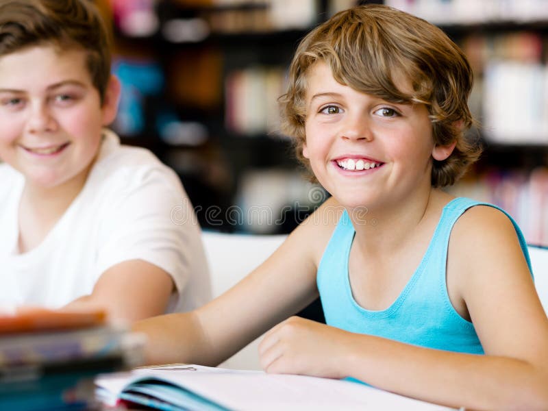 Two boys in library stock photo. Image of happy, education - 77059722