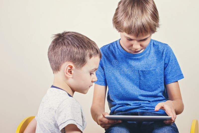 Two Boys Looking at Tablet Computer. Education, Learning, Technology ...