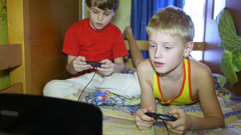 Two Boys Play a Computer Game with Joysticks in Stock Footage - Video ...