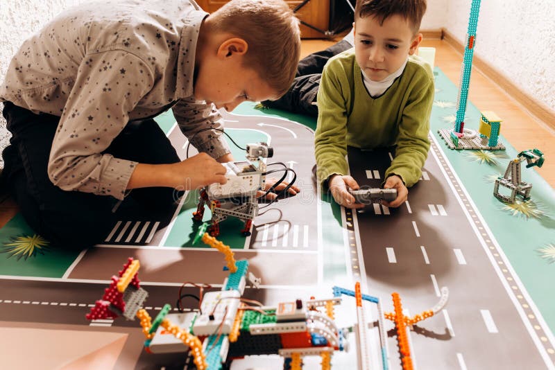 Two Boys Play with Robots that they Created from the Robotic ...