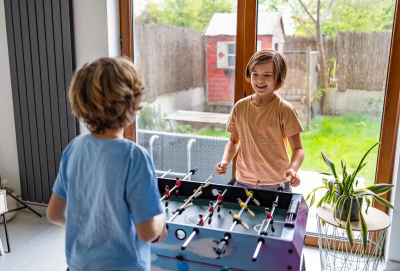 Two Boys Play Table Football Stock Photo - Image of house, childhood ...