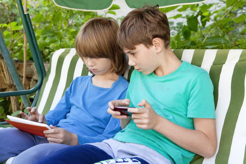 Two Boys Playing with Tablet Stock Image - Image of internet, outdoor ...