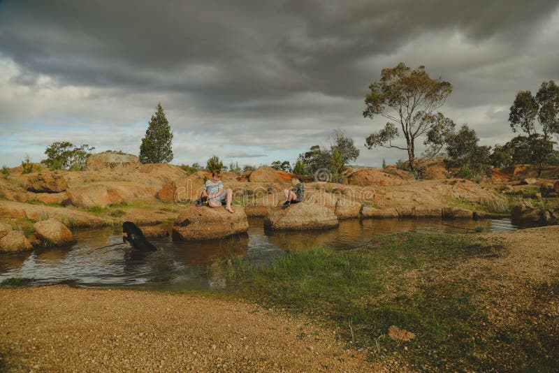 Two Boys Playing in Tranquil Waterhole in Australian Bush Setting Stock ...