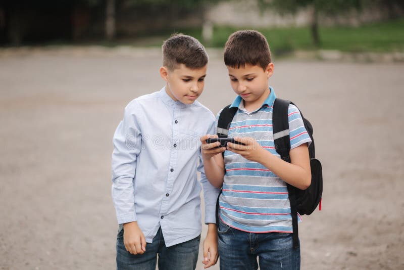 Two Boys Plays Online Games after School Classes. Young Boys Smile and ...