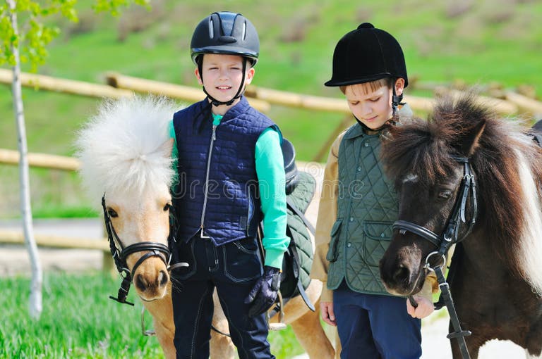 Two boys with ponies stock photo. Image of horseriding - 28642162