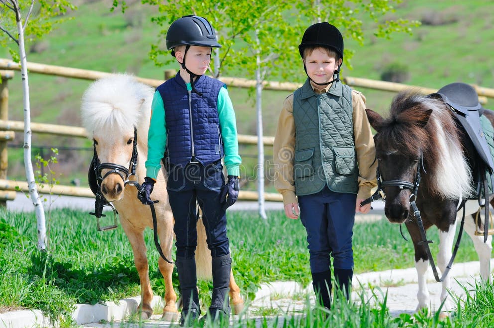 Two boys with ponies stock photo. Image of equitation - 28642346