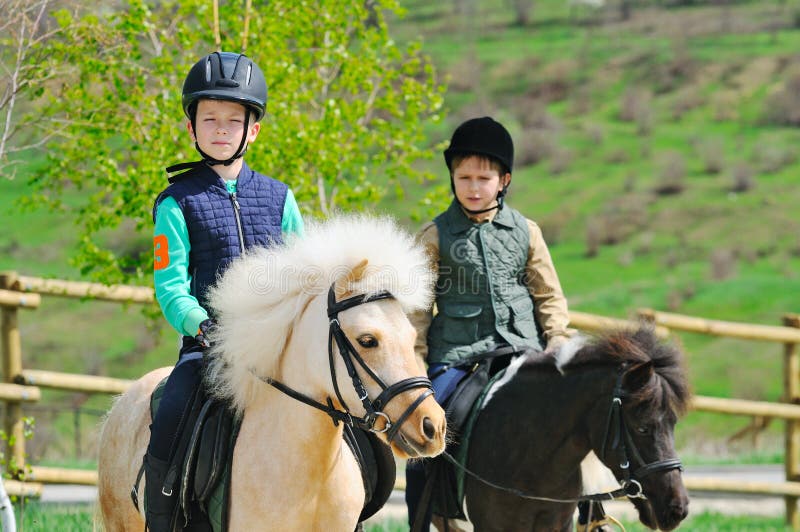 Two boys with ponies stock image. Image of palomino, chestnut - 28642583