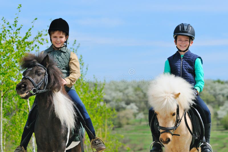 Two boys with ponies stock photo. Image of female, male - 28643024