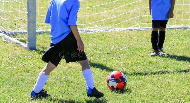 Two Boys Practice Soccer in Front of a Soccer Net Stock Image - Image ...