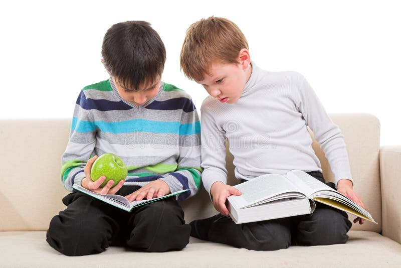 Two boys reading big book stock photo. Image of studio - 82710288