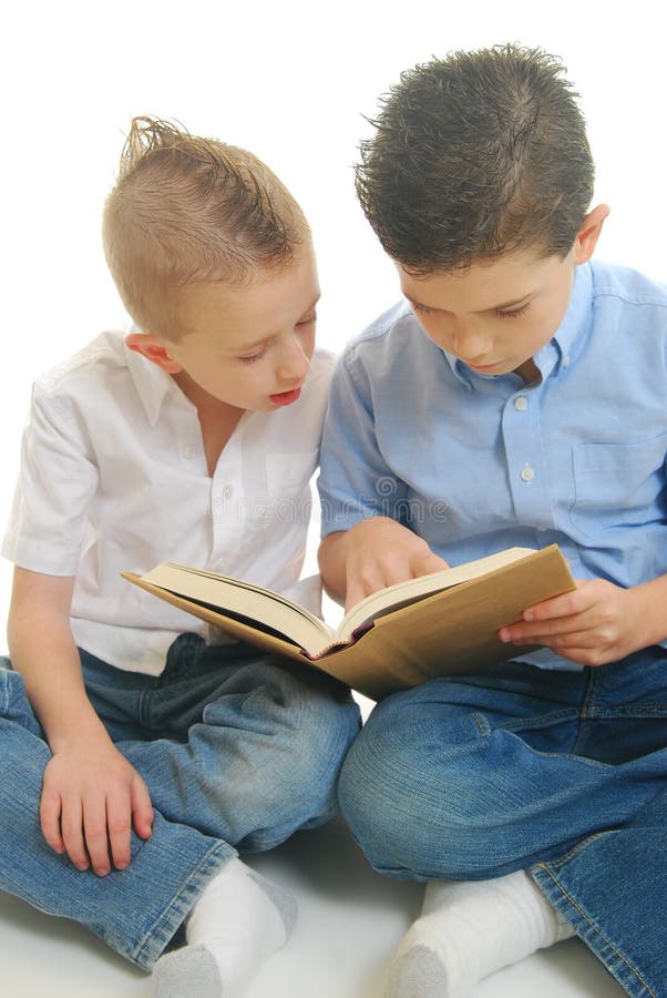 Two boys reading book stock image. Image of book, reading - 13543439