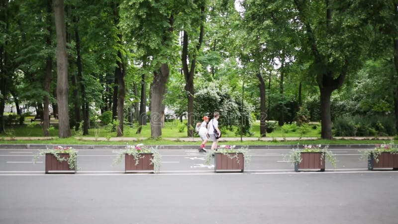 Two Boys Riding on Roller Skates on Roller Path in Stock Footage ...