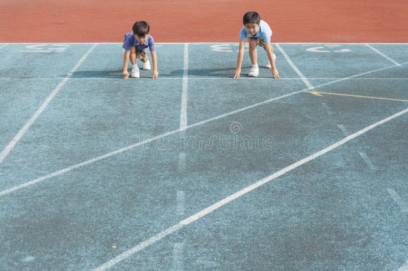 Two boys run on track stock image. Image of active, ready - 50242497