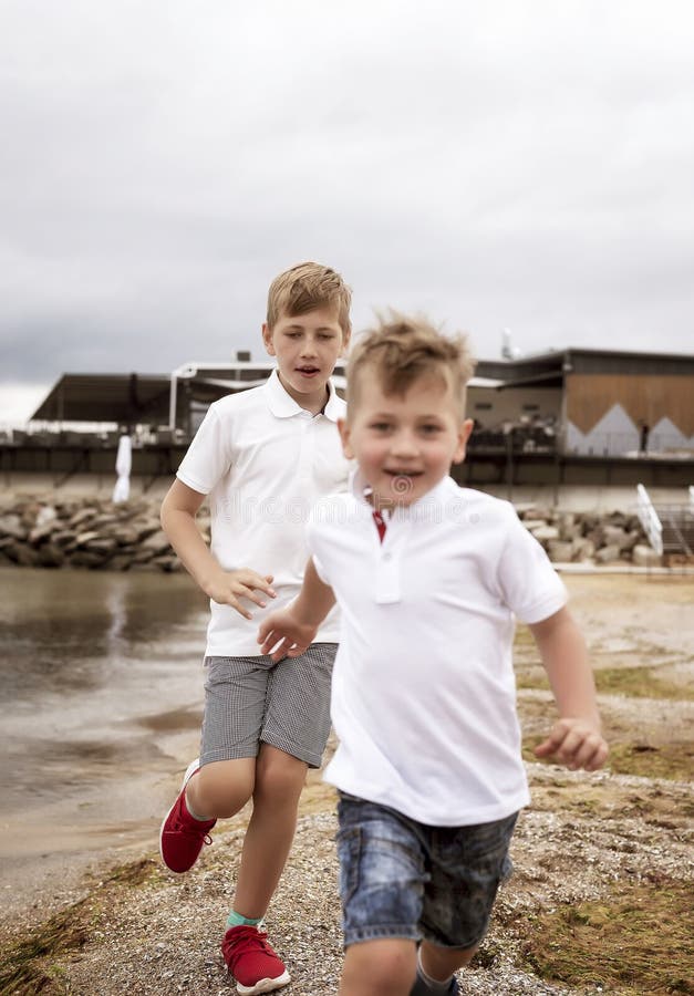 Two Boys are Running on the Beach. Stock Photo - Image of kids, meadow ...