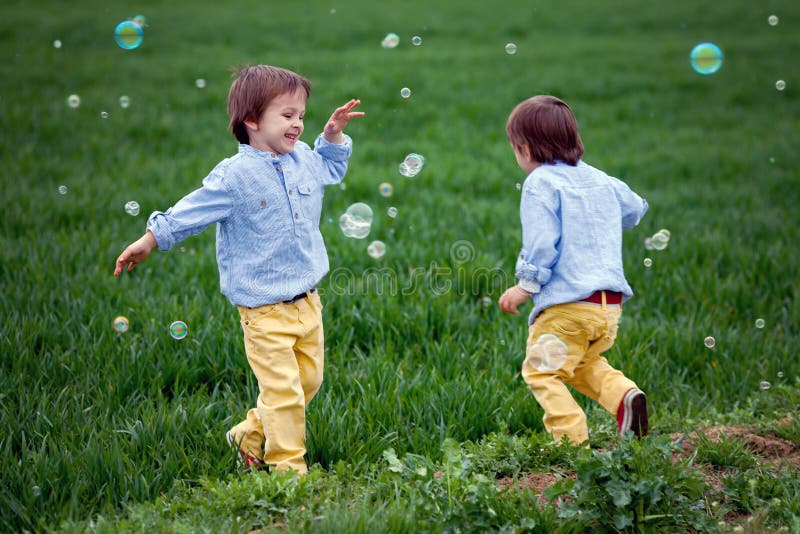 Two Boys, Running and Chasing Soap Bubbles Stock Image - Image of ...