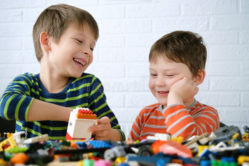 Two Boys Sit Down at the Table and Assemble the Designer. Children ...