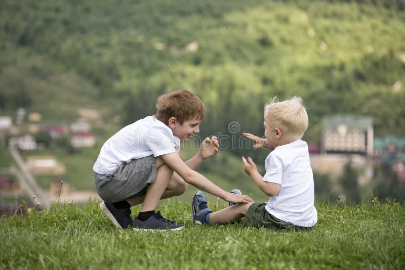 Two Boys Sit on a Hill and Have Fun. Back View Stock Image - Image of ...