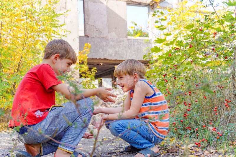 Two Boys Sit Opposite Each Other in the Park and Communicate with Each ...
