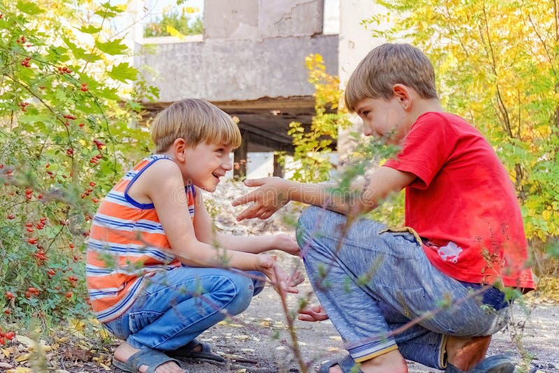 Two Boys Sit Opposite Each Other in the Park and Communicate with Each ...