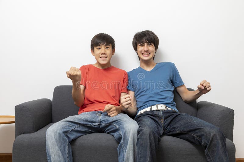 Two Boys Sitting on Sofa and Watching TV Together. Stock Image - Image of indoor, multi: 300831239