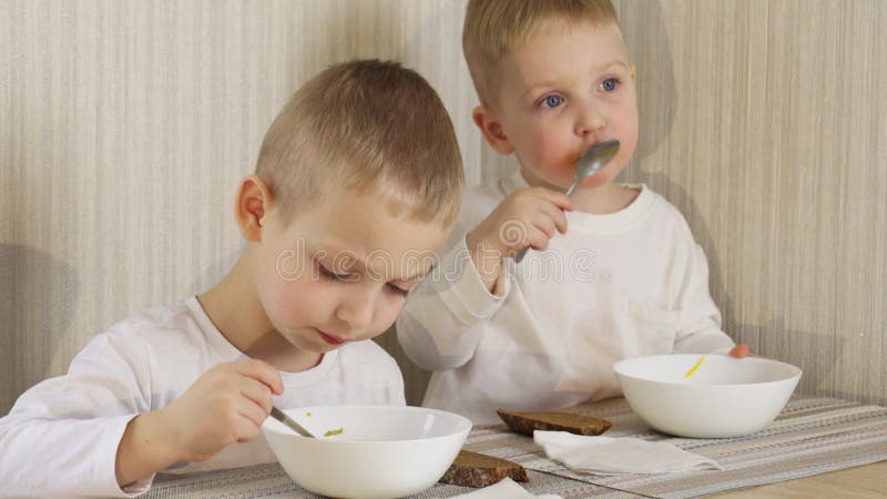 Two Boys are Sitting at the Table Eating Soup Stock Video - Video of ...