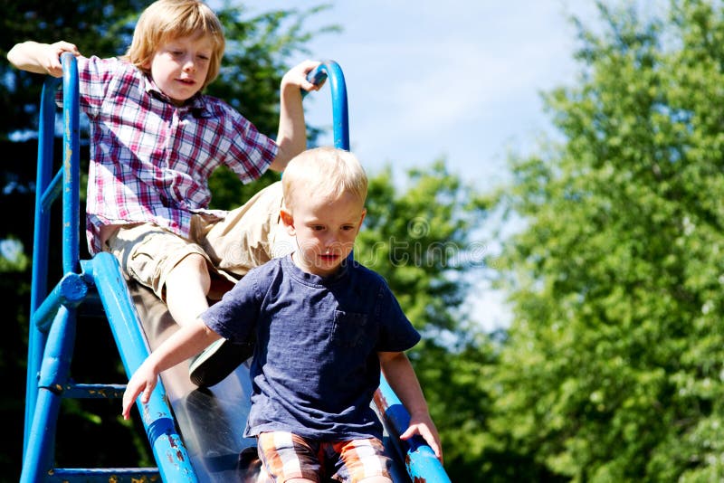 Two boys on slide stock image. Image of youth, park, active - 50913189