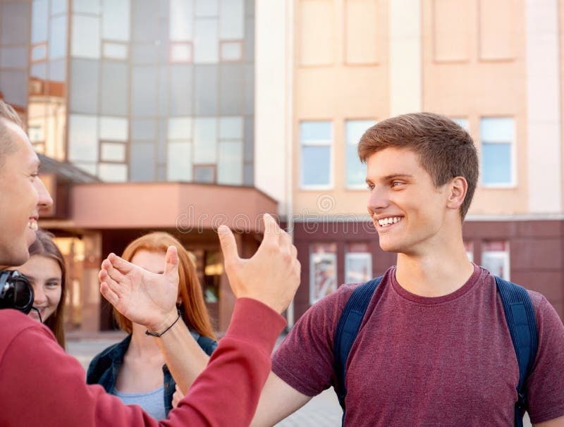 Two Boys Students Greeting Each Other Near Campus Stock Photo - Image ...