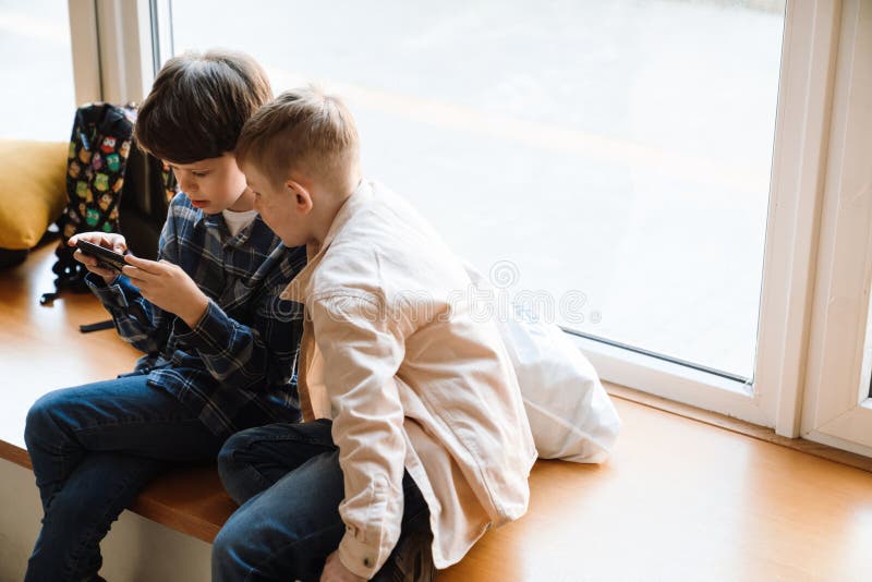Two Boys Using Mobile Phone while Sitting in Classroom Stock Image ...