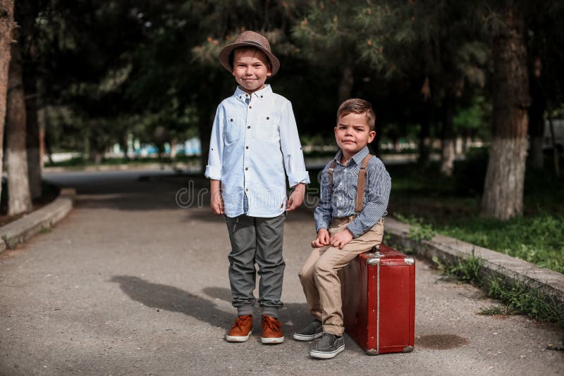 Two Boys Sit Opposite Each Other in the Park and Communicate with Each ...