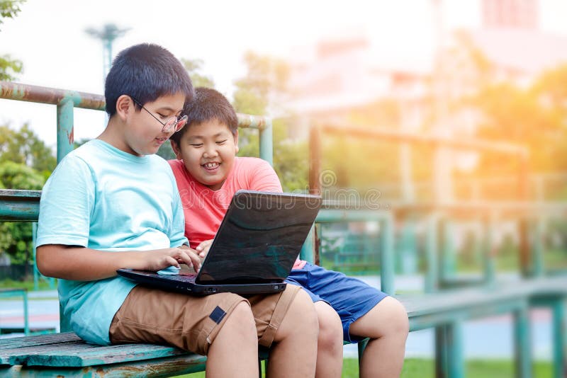 Two Boys Watching Computers Smile and Laugh Stock Image - Image of ...