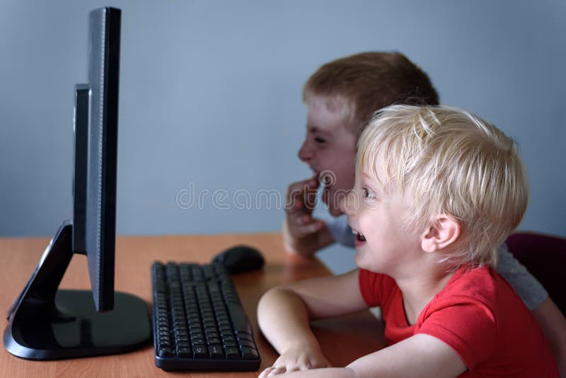 Two Boys are Watching Something on the Computer with a Laugh. Children ...