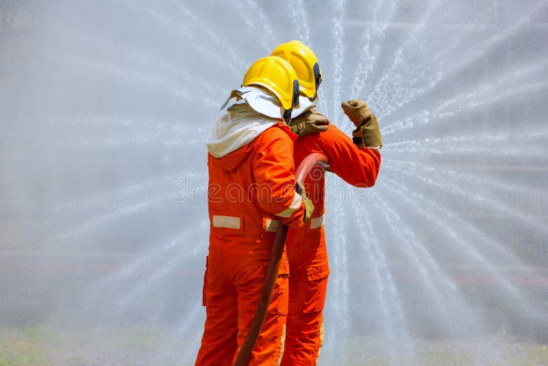 Two Brave Firefighter Using Extinguisher and Water from Hose for Fire ...