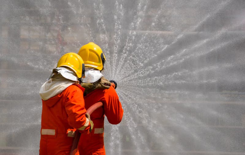 Two Brave Firefighter Using Extinguisher and Water from Hose for Fire ...