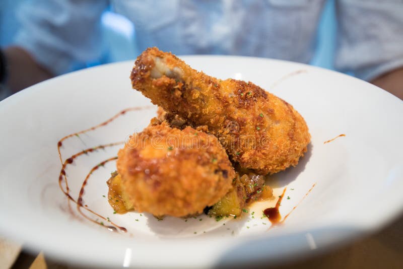 Closeup Breaded Chicken Legs in White Deep Plate Stock Photo - Image of ...