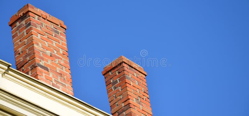 Two brick chimneys stock photo. Image of building, terracotta - 36203116